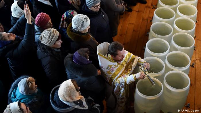 Orthodox Christians take Epiphany ice baths | All media content | DW ...